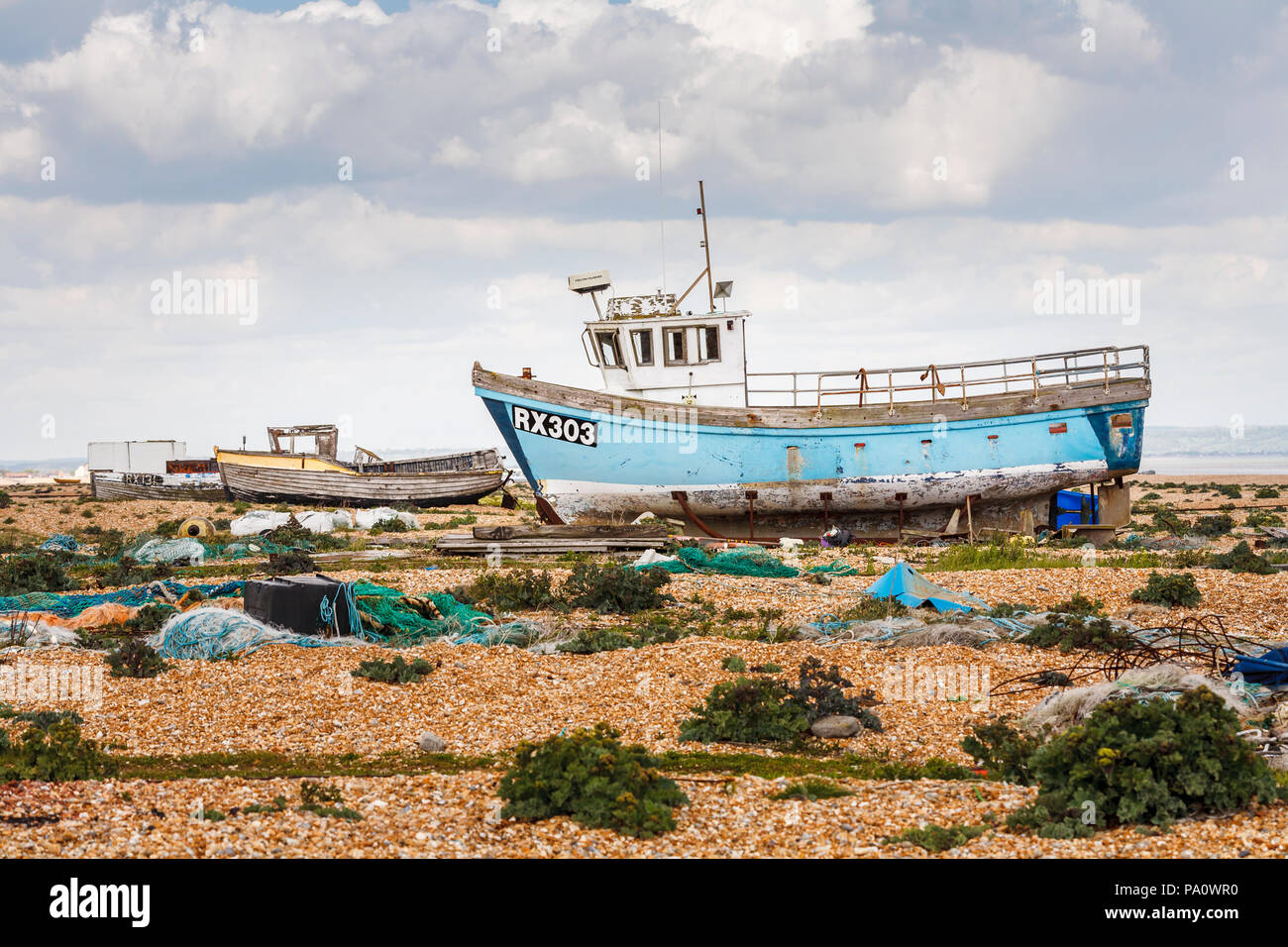 Remains of a blue abandoned wooden fishing boat falling apart on the ...