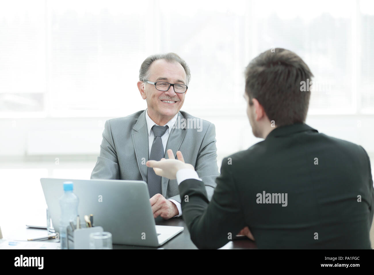 close up.business people talking at a Desk Stock Photo - Alamy
