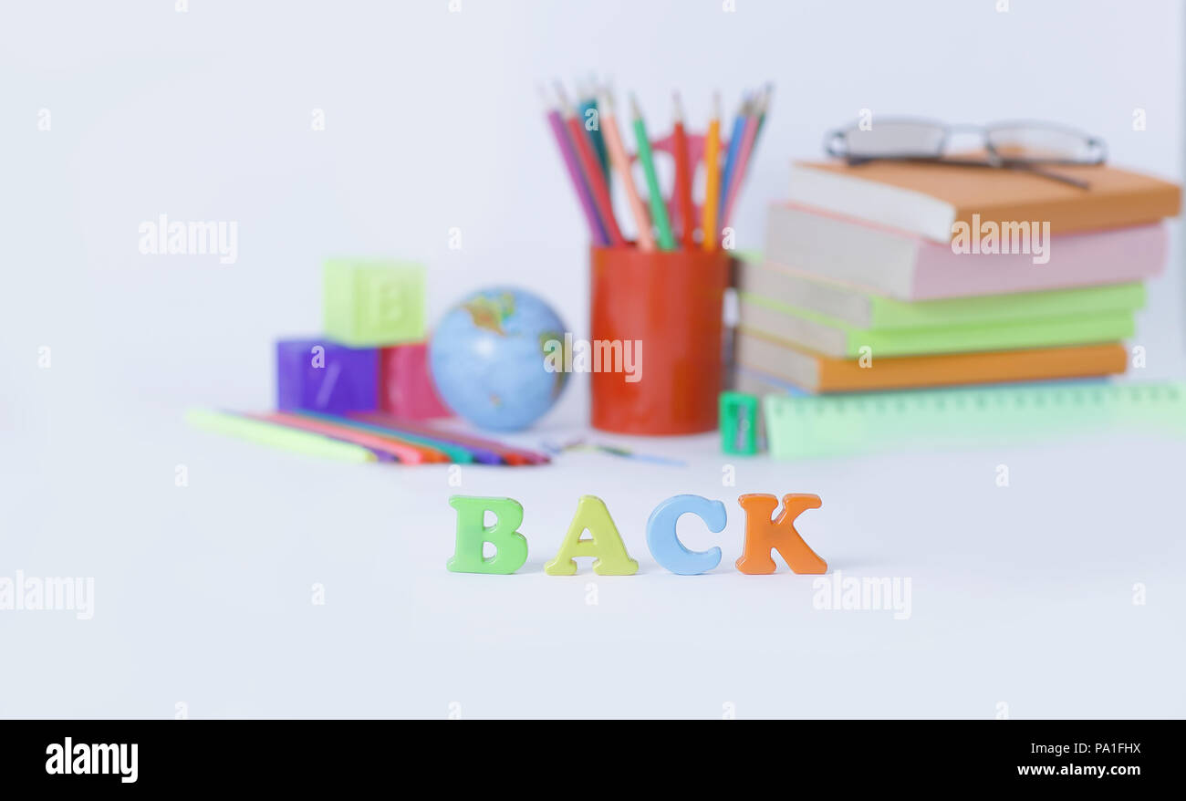 word back on blurred background school supplies .photo with copy space ...