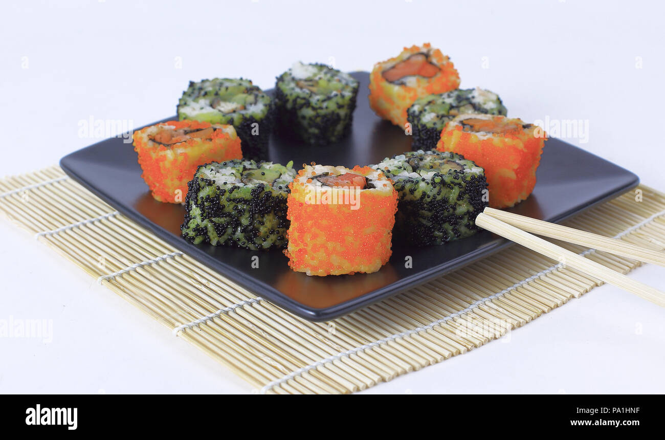 Sushi Set - different types of Maki sushi and chopsticks on a b Stock ...