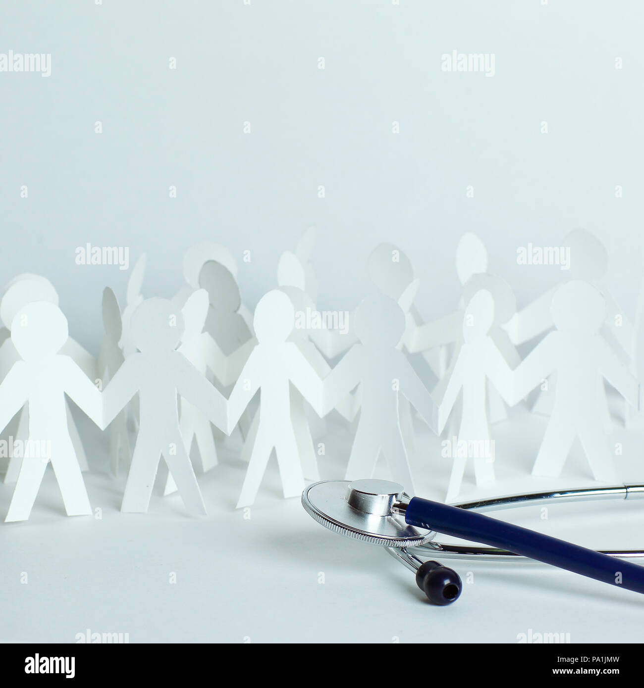 stethoscope and paper men on the table Stock Photo - Alamy