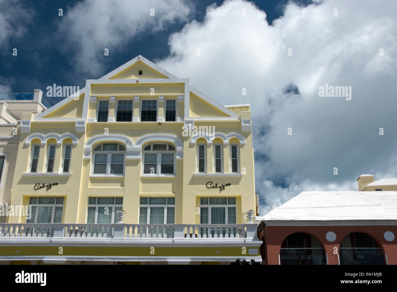 A colorful British colonial style building houses shops along Front ...