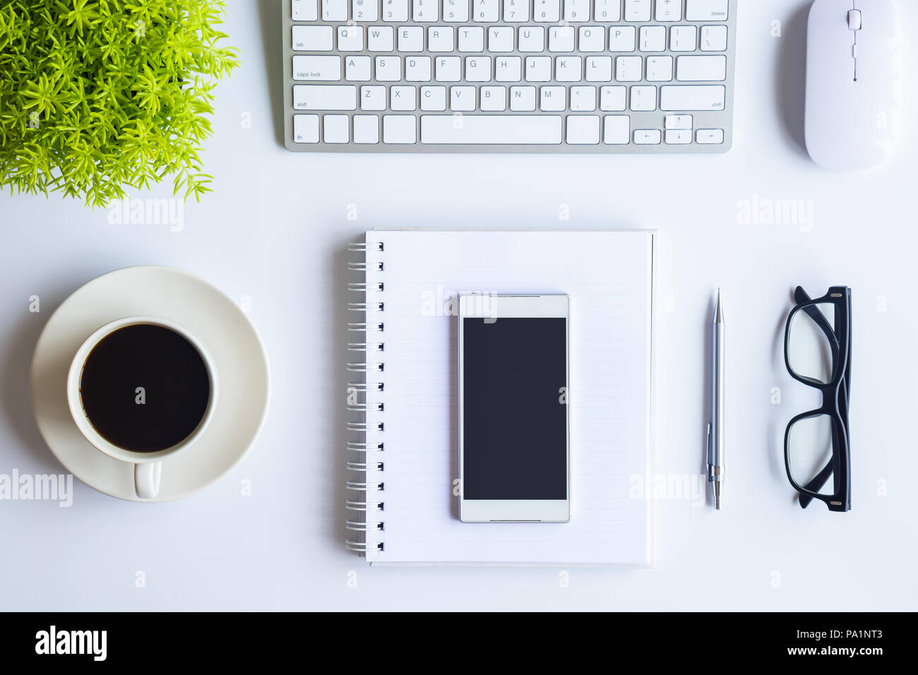 White desk office with laptop, smartphone and other work supplies with ...