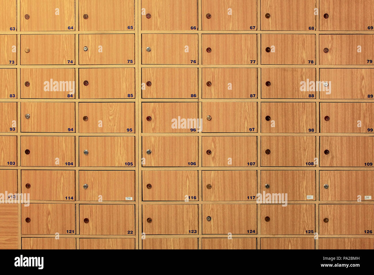 Wooden locker boxes, with metal locks in the post office Stock Photo ...