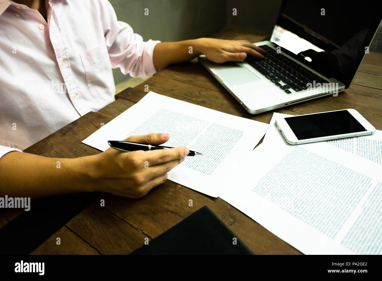 Businessman working at office with laptop and documents on the table ...