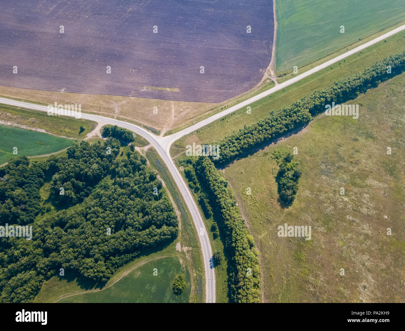 Helicopter drone shot. Aerial photography of green forest with road ...