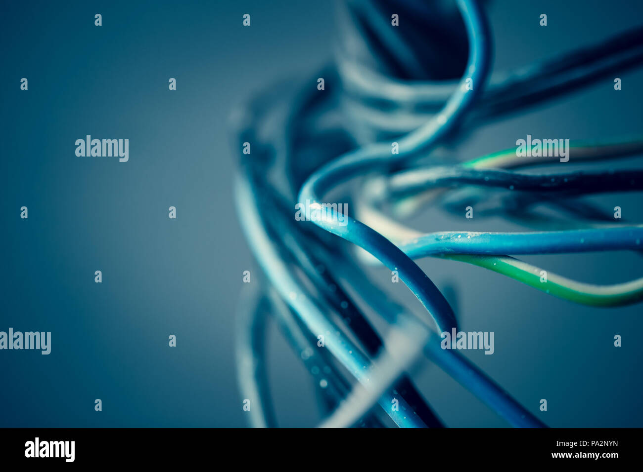 Closeup photo of the cables isolated on blue background, abstract ...