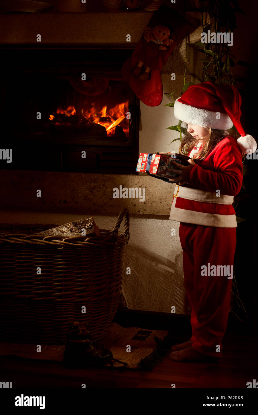 Little caucasian girl disguised as Santa Claus Stock Photo - Alamy