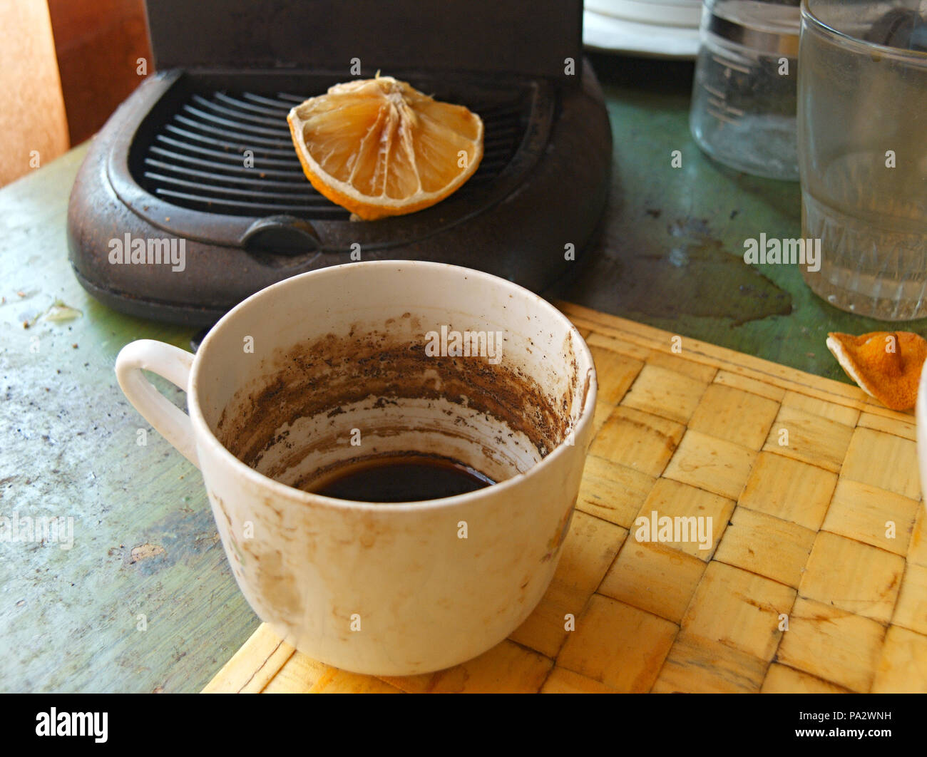 Closeup of a dirty coffee cup, dry lemon on a messy table top Stock ...