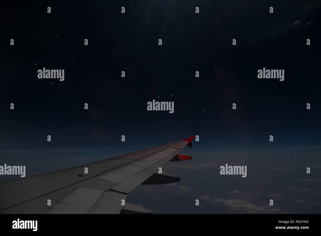 Plane travel, a civil aircraft's wing cruising above the clouds at ...