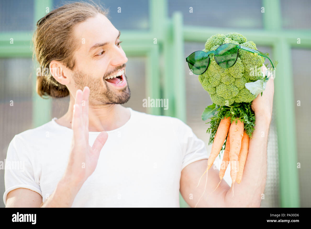 Funny portrait of a man with his vegetable friend made of broccoli and ...
