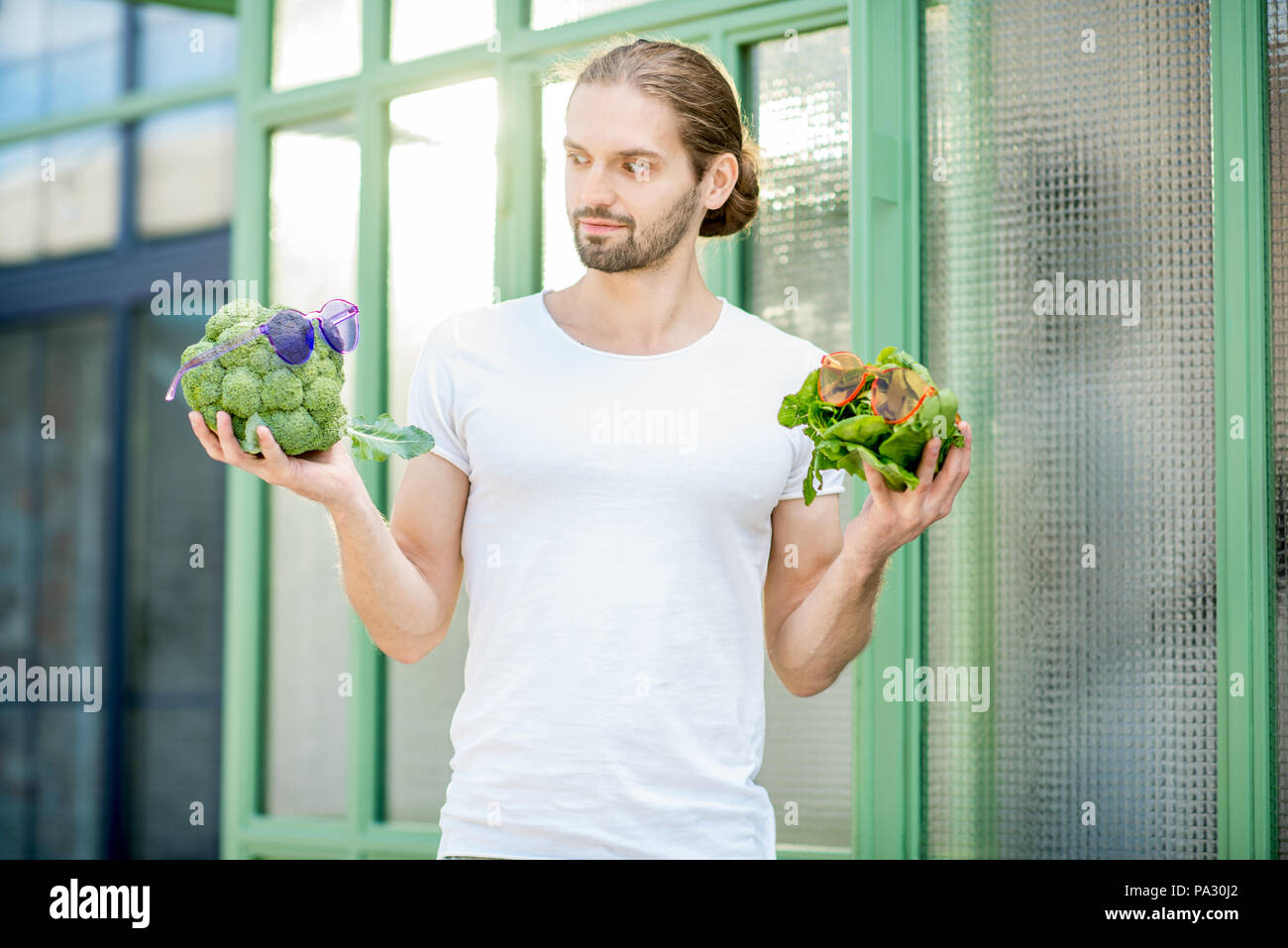 Funny portrait of a man with his vegetable friends made of broccoli and ...