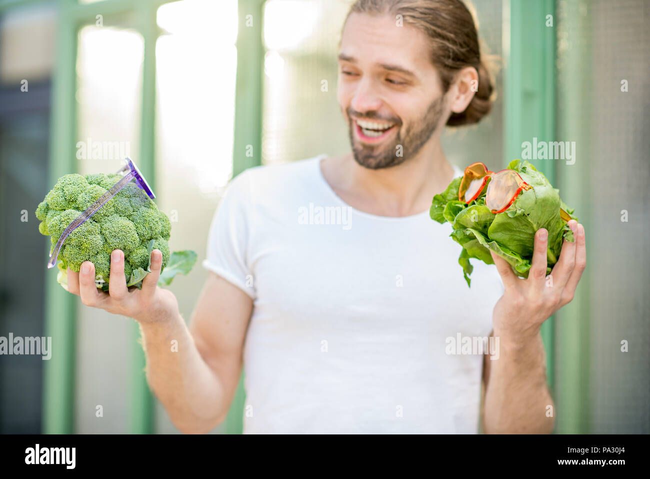 Funny portrait of a man with his vegetable friends made of broccoli and ...
