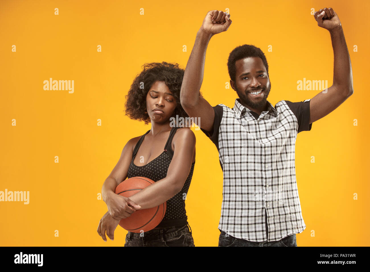 The happy and angry fans on colored gold background Stock Photo - Alamy