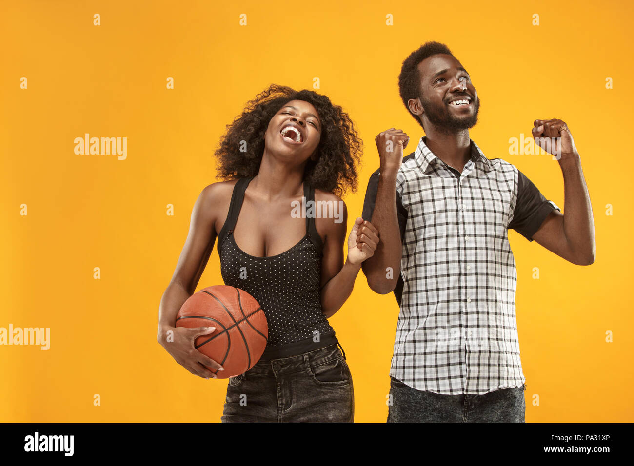The happy and angry fans on colored gold background Stock Photo - Alamy