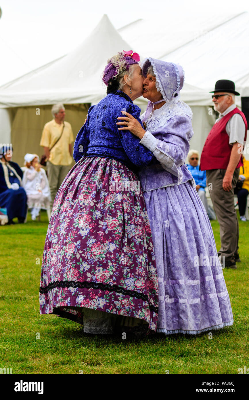 Two senior upper class ladies greeting each other by cheek kissing ...