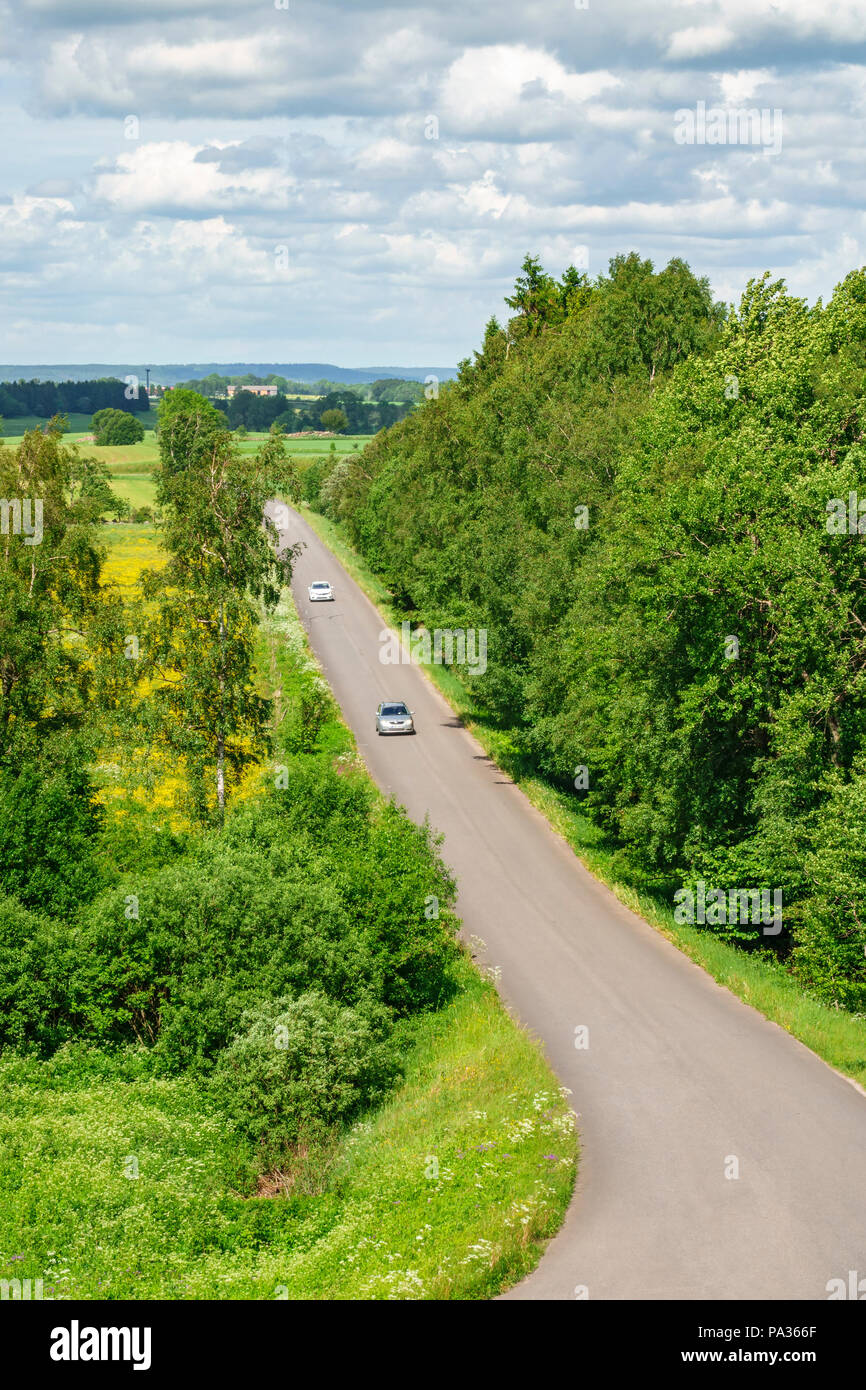 Cars driving in a country road Stock Photo - Alamy
