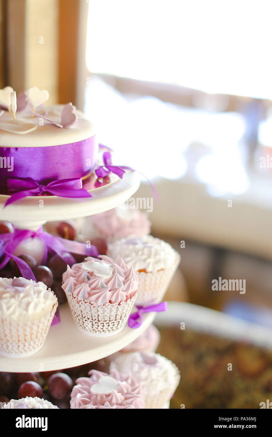 Violet decorations and sweet cakes for party Stock Photo - Alamy