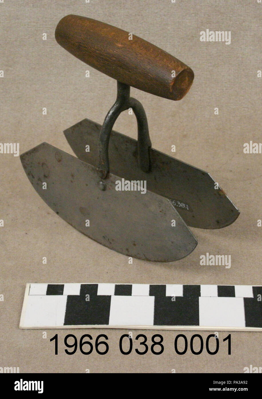 . English: Double blade food chopper has forked metal bar to loop ...