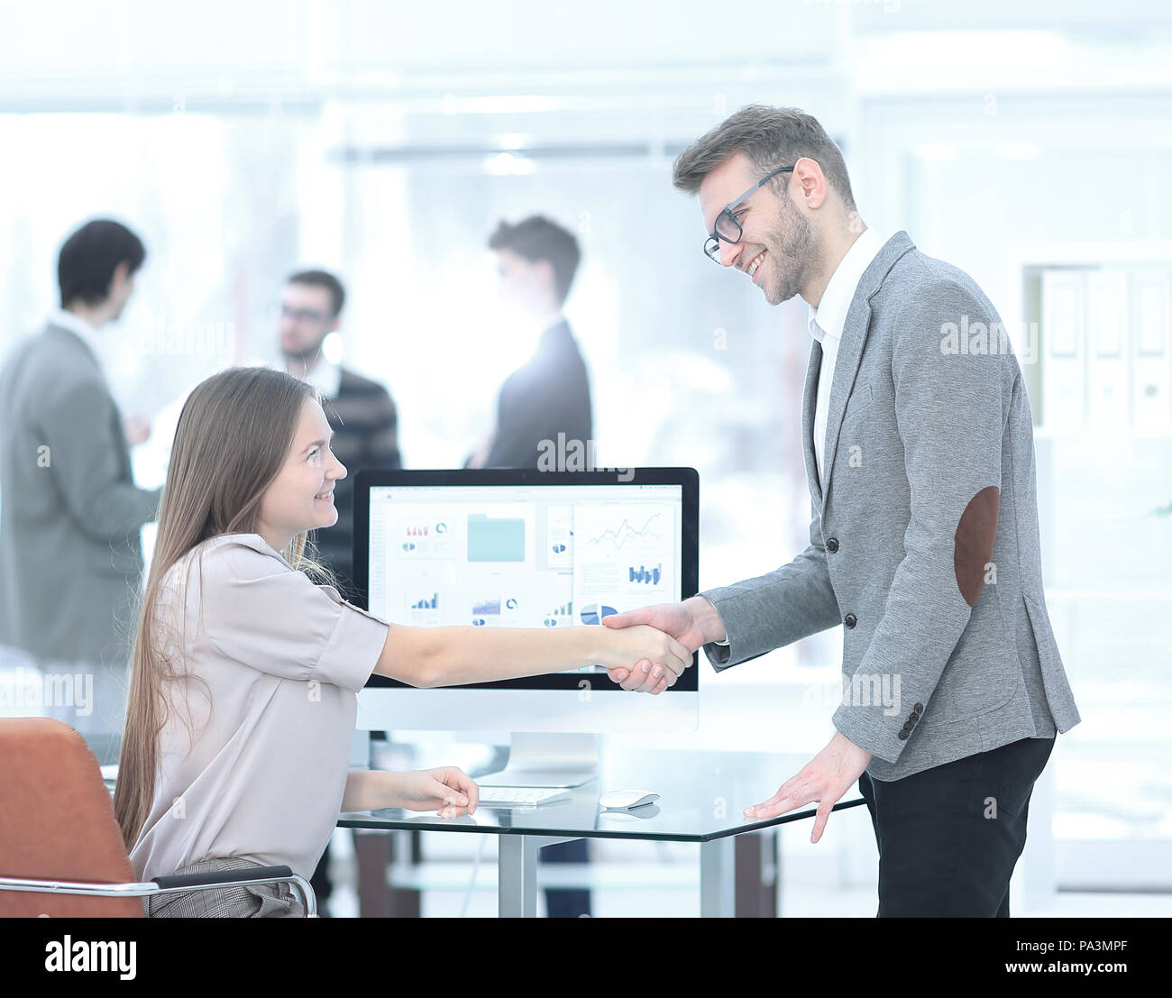 Manager and employee shaking hands to each other as a sign of success ...