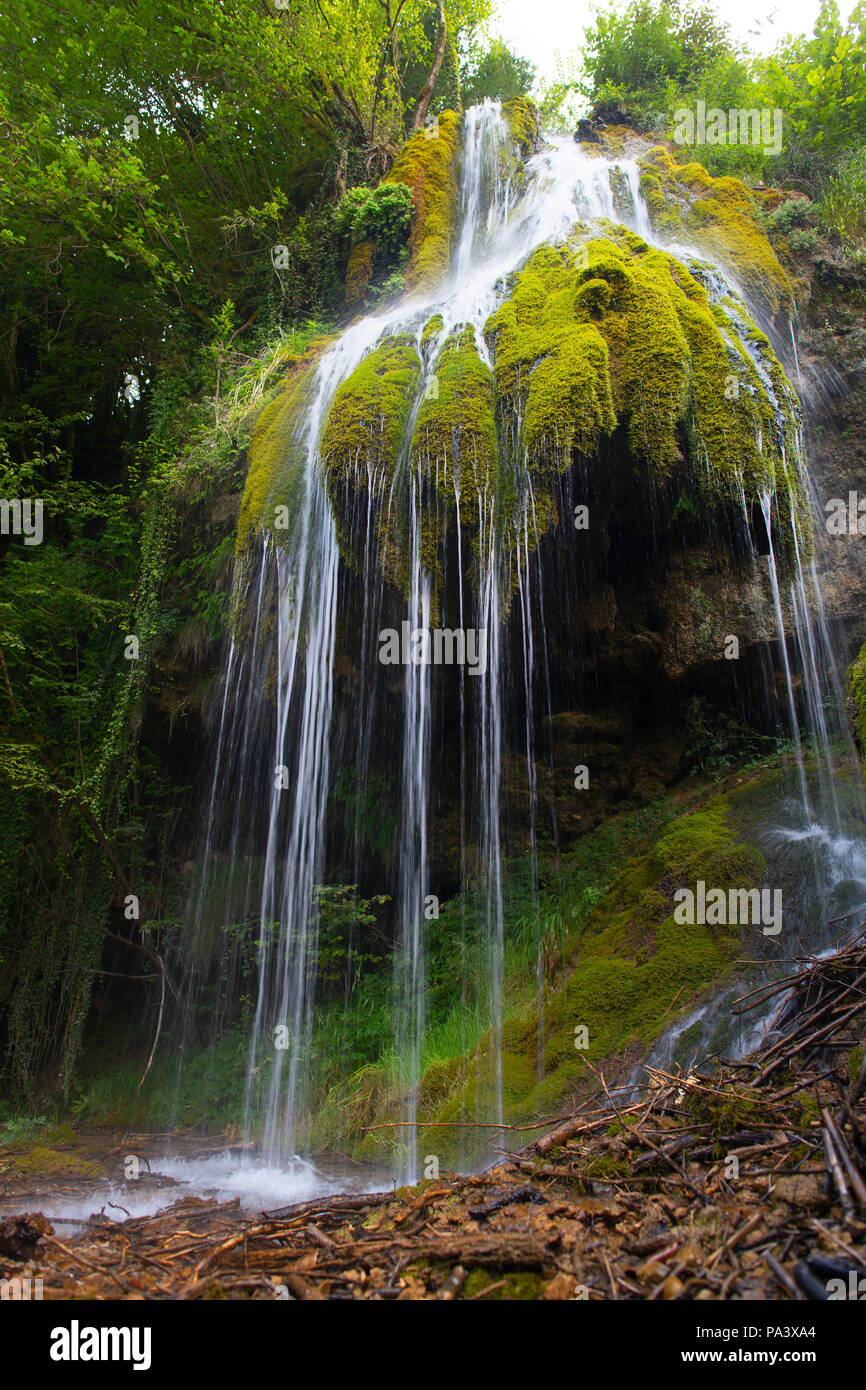 Small waterfall of water between the moss above a cave Stock Photo - Alamy