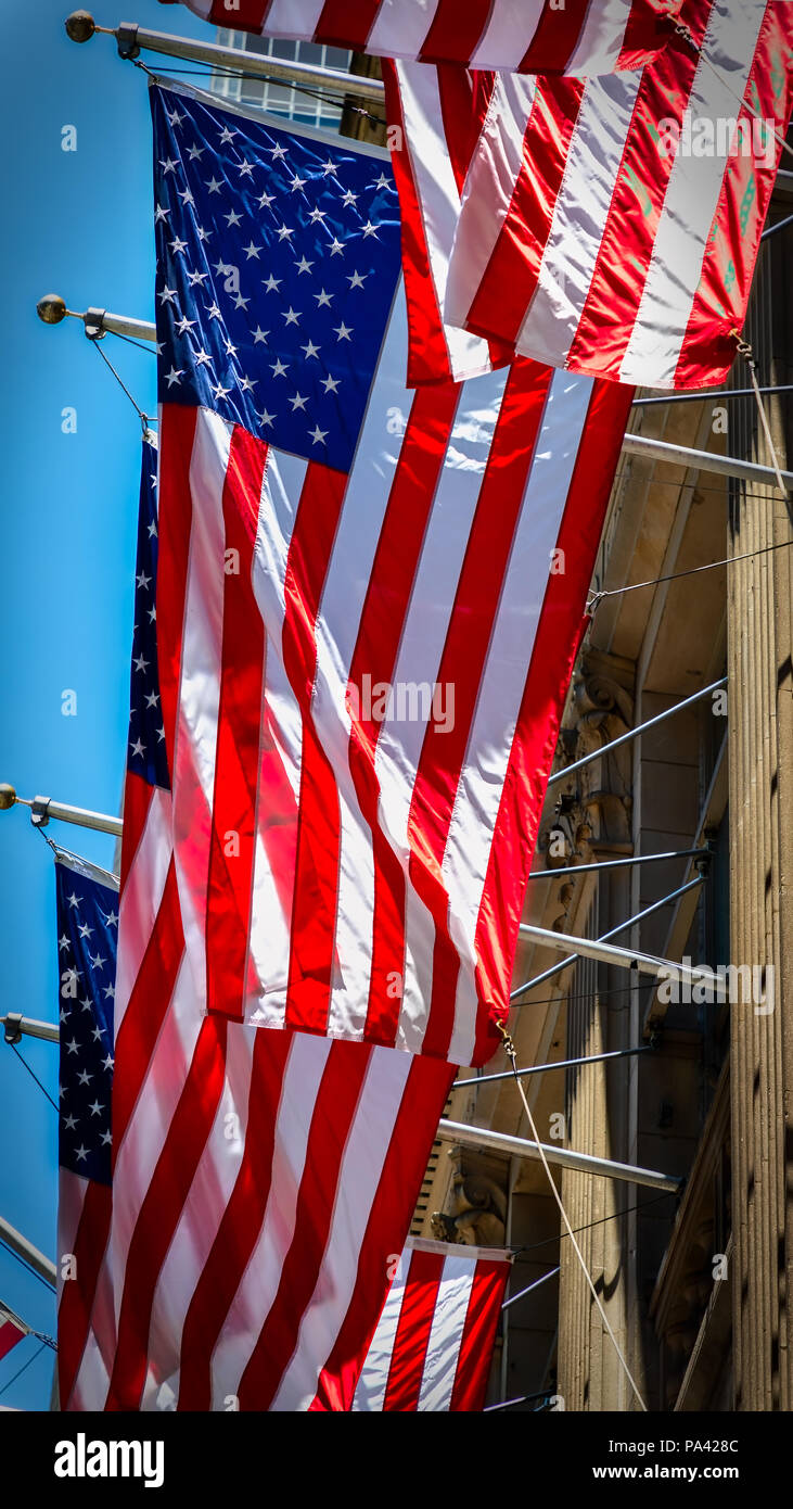Multiple American flags blowing in the wind while hanging from ...