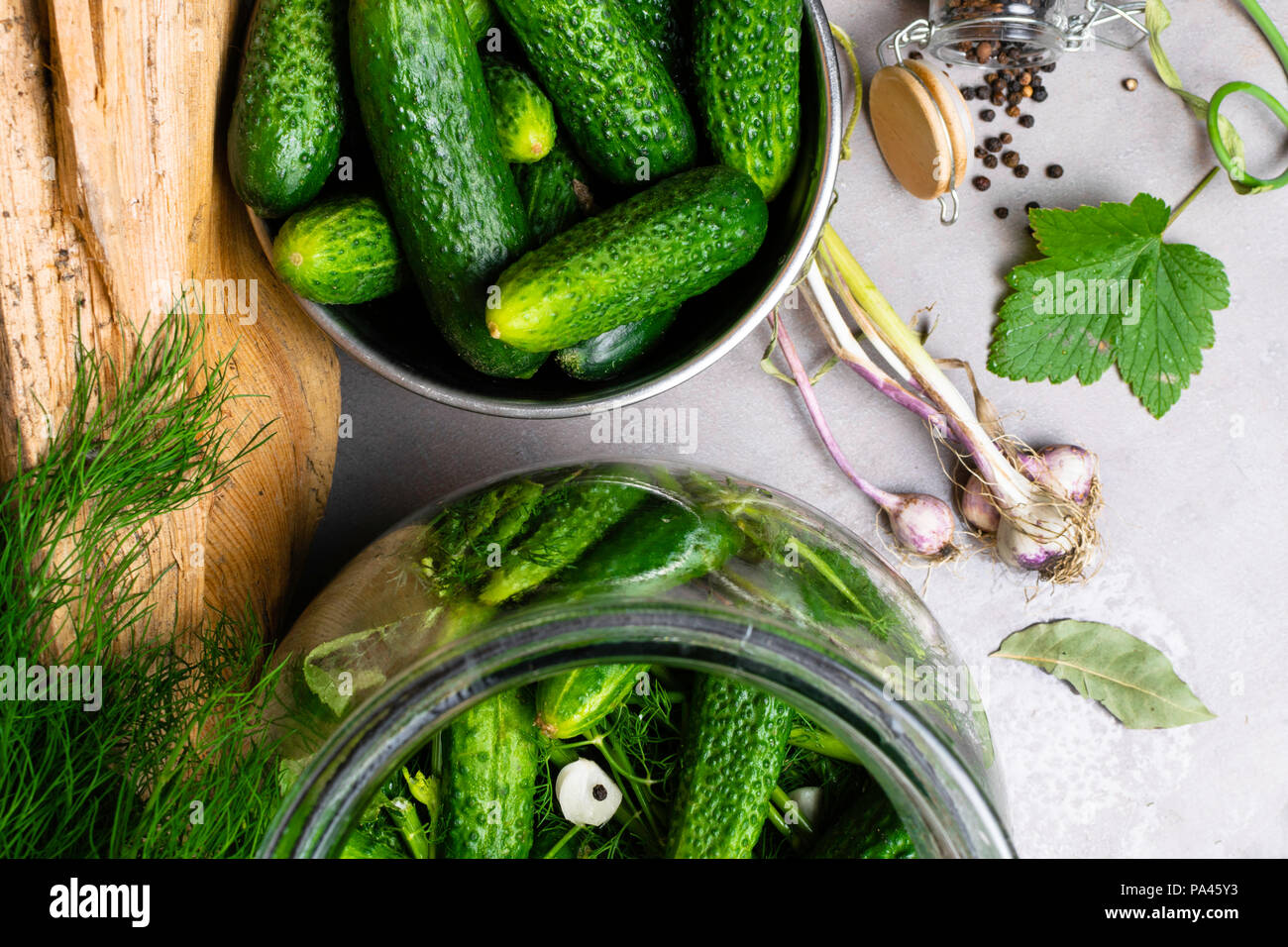 Cucumbers, dill, pepper, ingredients for conservation are scattered on ...