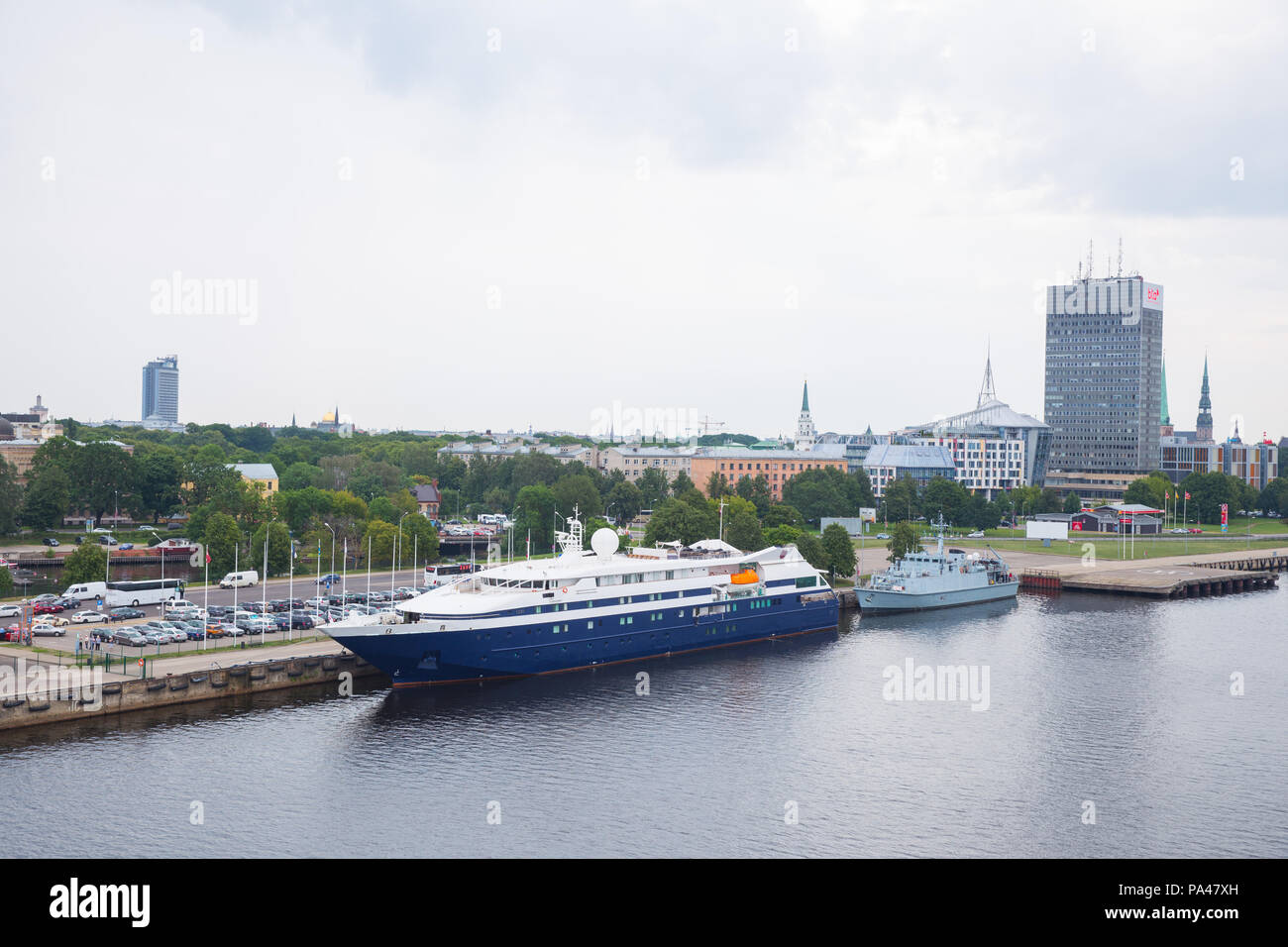 City Riga, Latvia. Ship at River Daugava, port and buildings. Urban ...