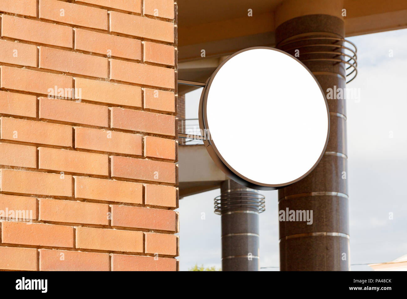Blank shop sign om brick wall. Round signage mockup. 3d illustration ...