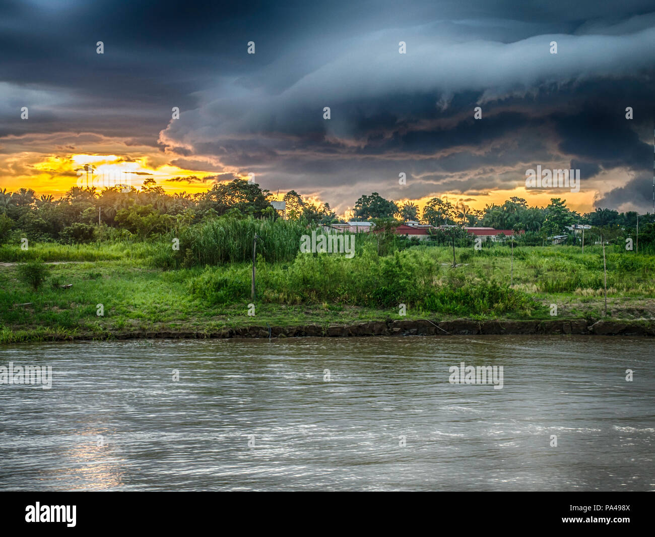 Sunset and dramatic clouds before the storm on the sky over the Amazon ...