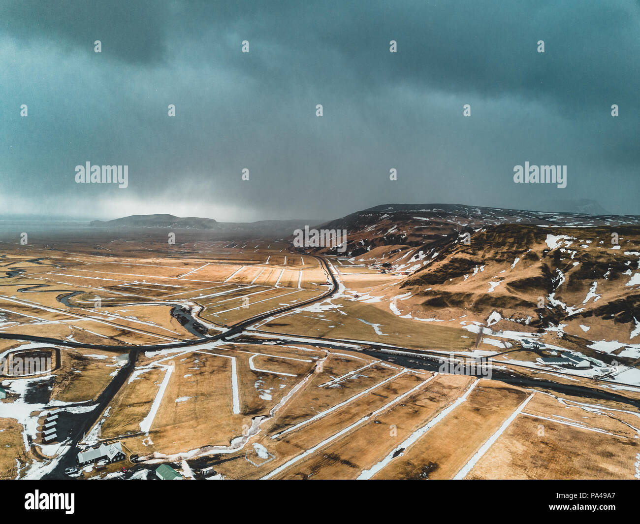 Iceland aerial view Landscape with snow and clouds, street and yellow ...