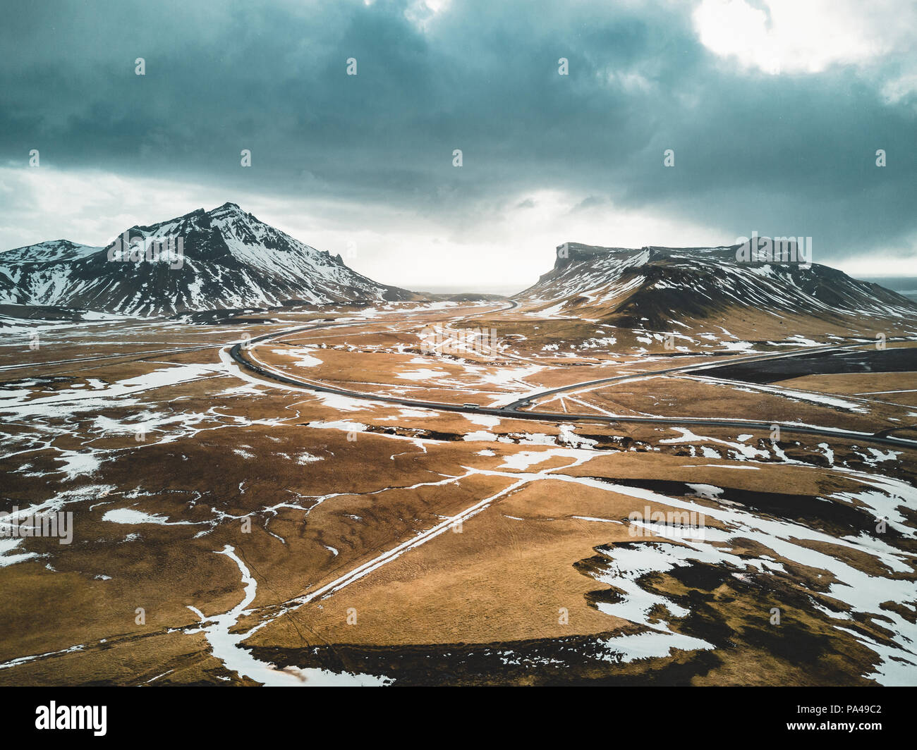 Iceland aerial view Landscape with snow and clouds, street and yellow ...