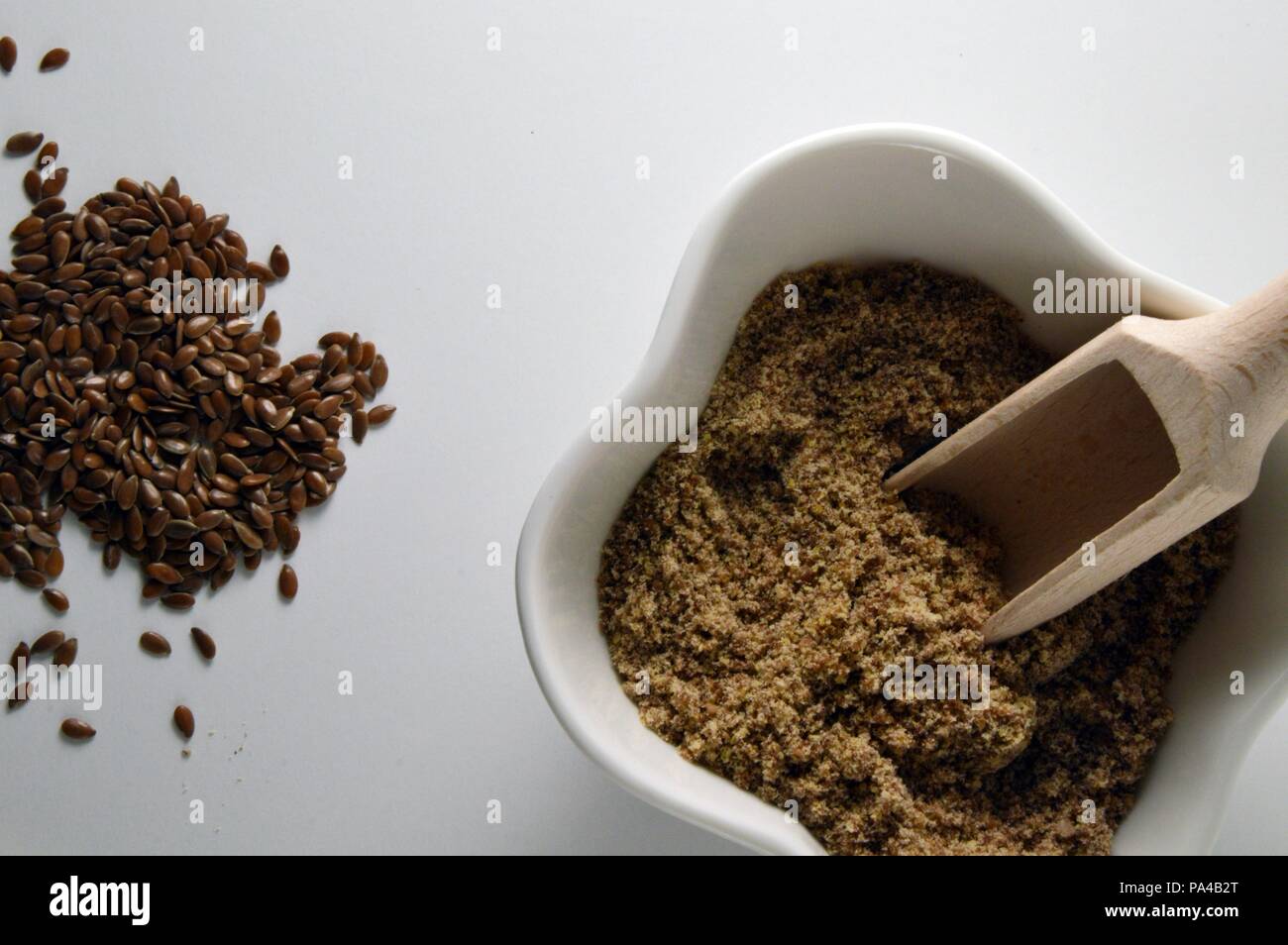 ground and whole linseeds (flax seeds) on white background Stock Photo ...