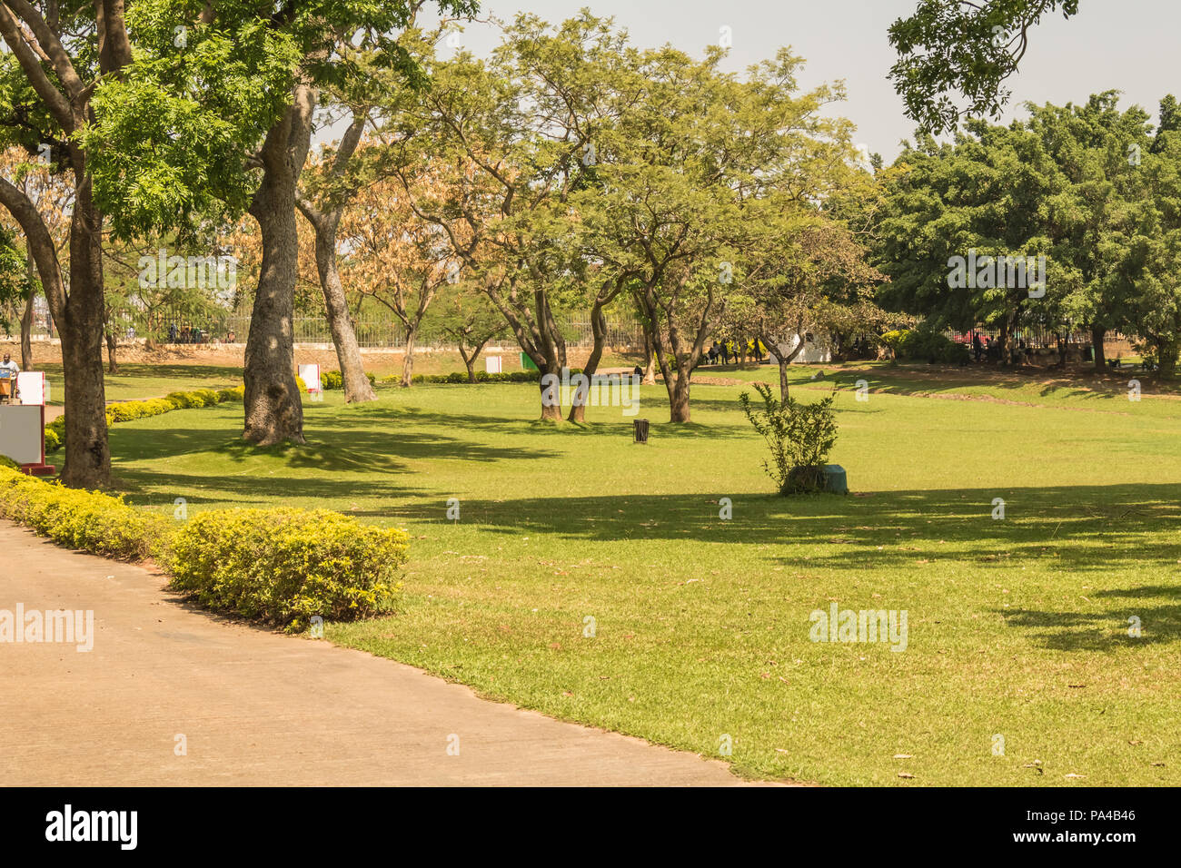 A beautiful city green freshly mowed park with colourful flowers and ...