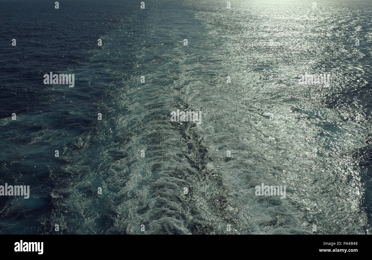 Wake of a cruise ship against the light Stock Photo - Alamy