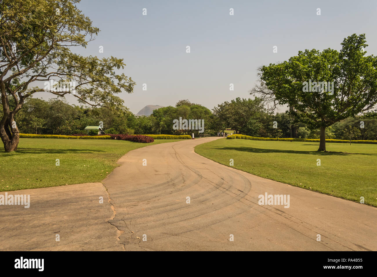 A beautiful city green freshly mowed park with colourful flowers and ...