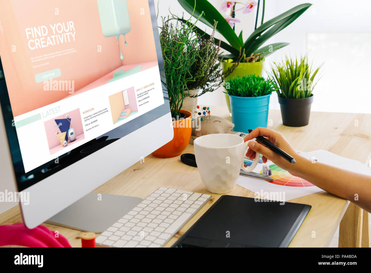 Graphic designer using pen tablet to learn graphic design. All screen ...