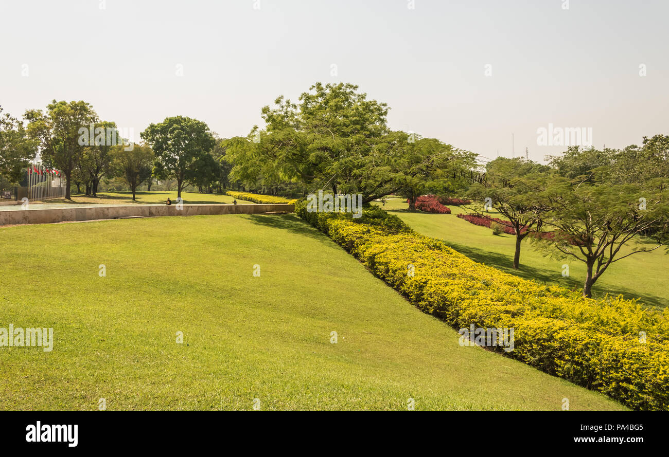 A beautiful city green freshly mowed park with colourful flowers and ...