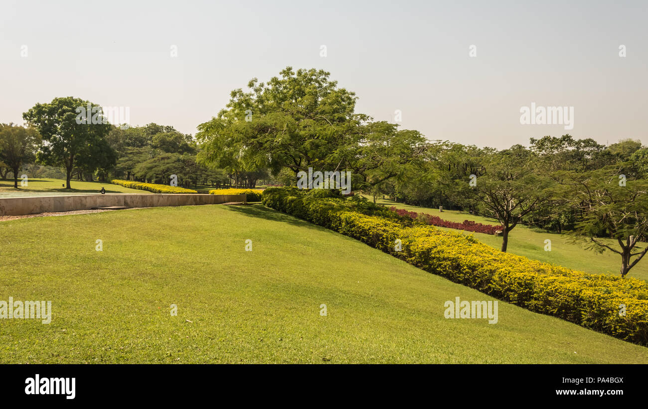A Beautiful City Green Freshly Mowed Park With Colourful Flowers And a-beautiful-city-green-freshly-mowed-park-with-colourful-flowers-and