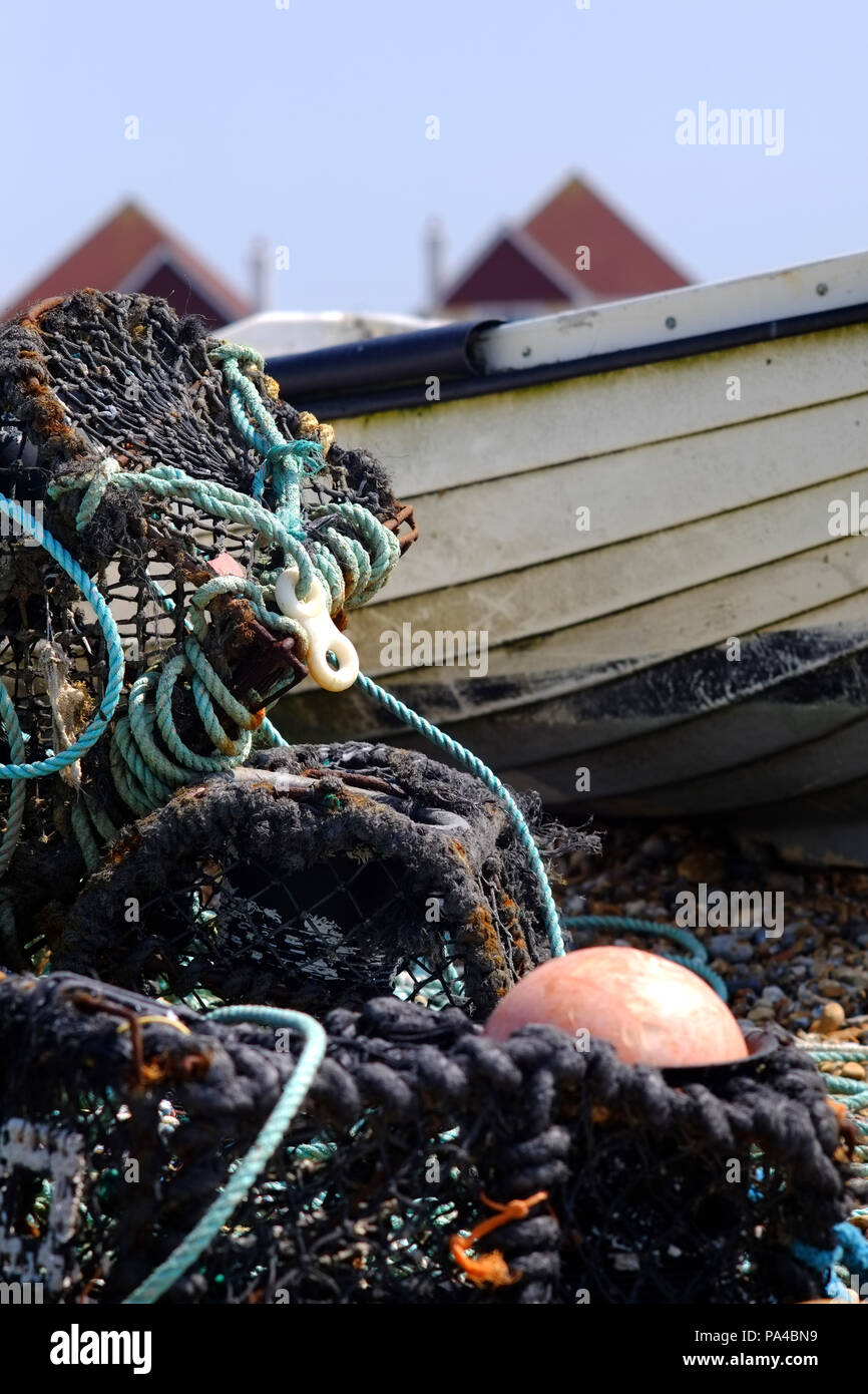 Old lobster pots and fishing nets on a beach Stock Photo - Alamy