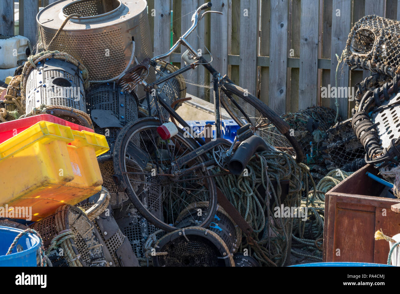 a pile of rusty old scrap metal in a boatyard with an old bicycle ...