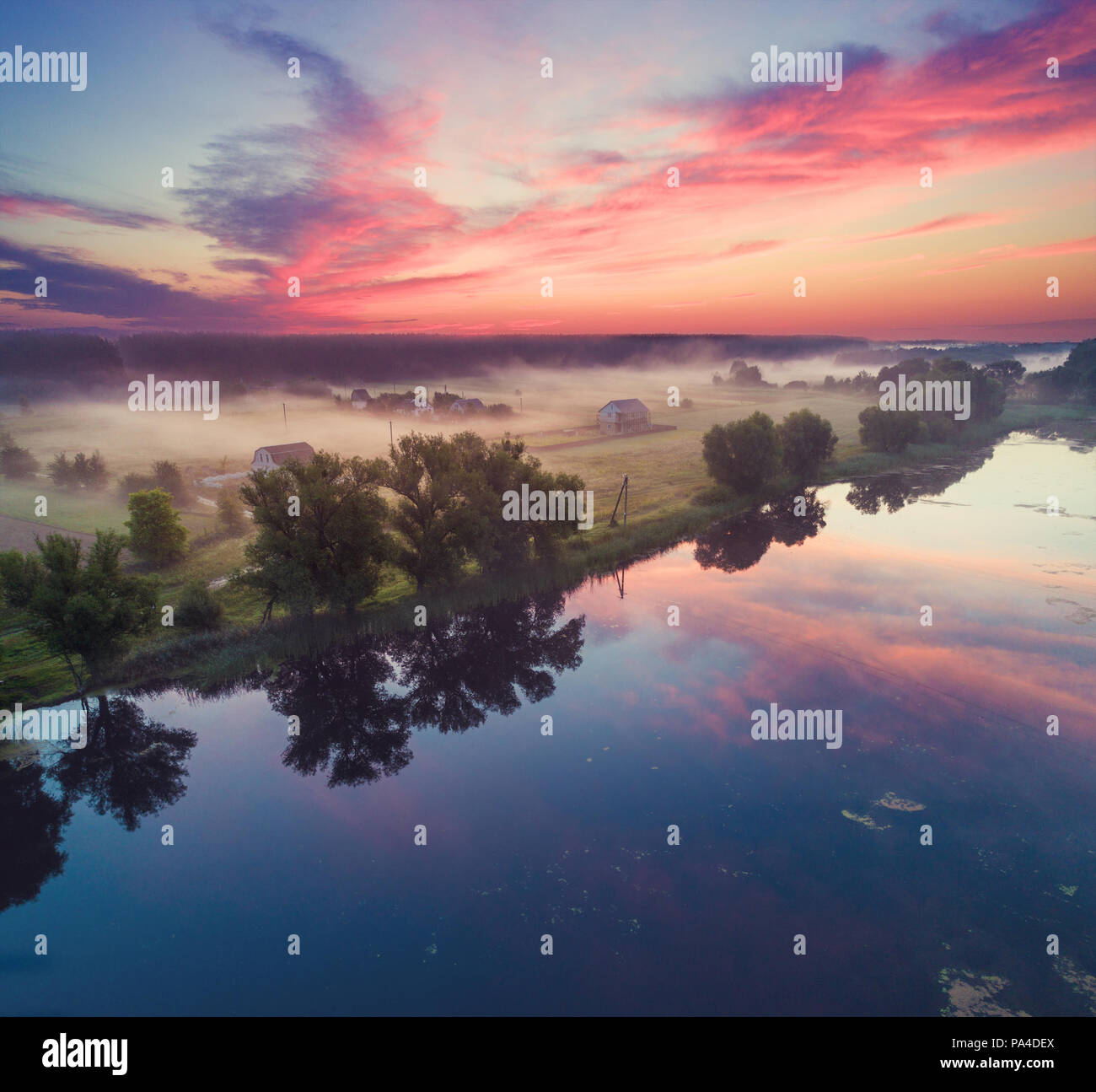 Aerial view of countryside and river in early misty morning. The time ...