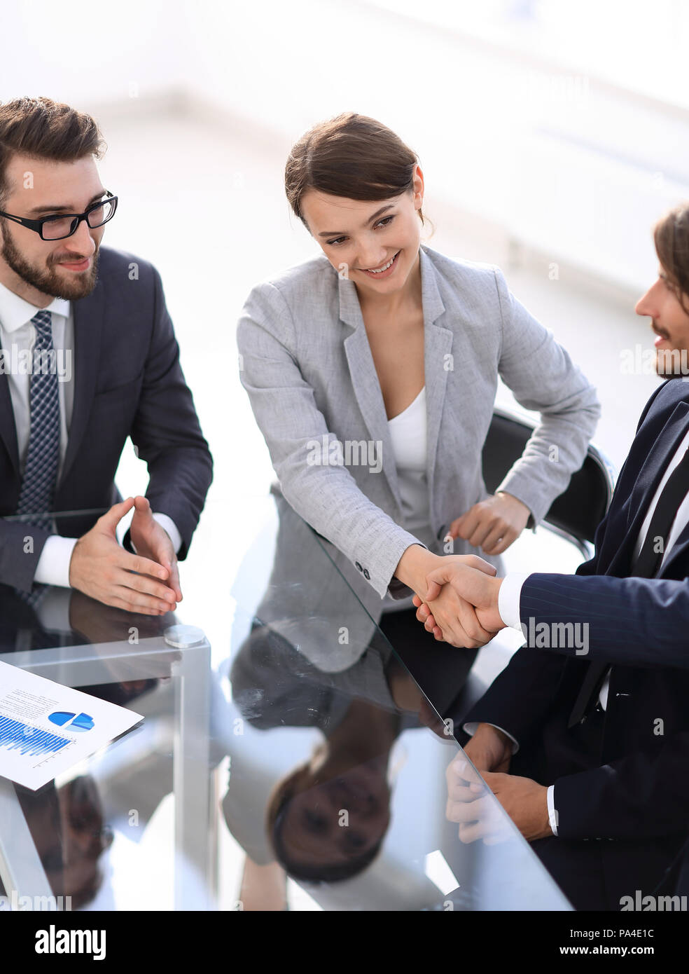 handshake business partners for their Desk Stock Photo - Alamy