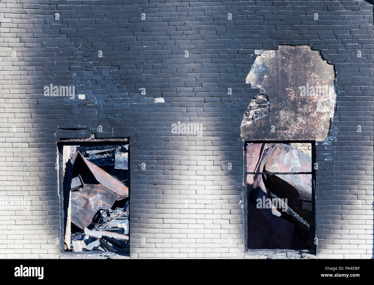 two windows and part of the wall of the brick building after the fire ...