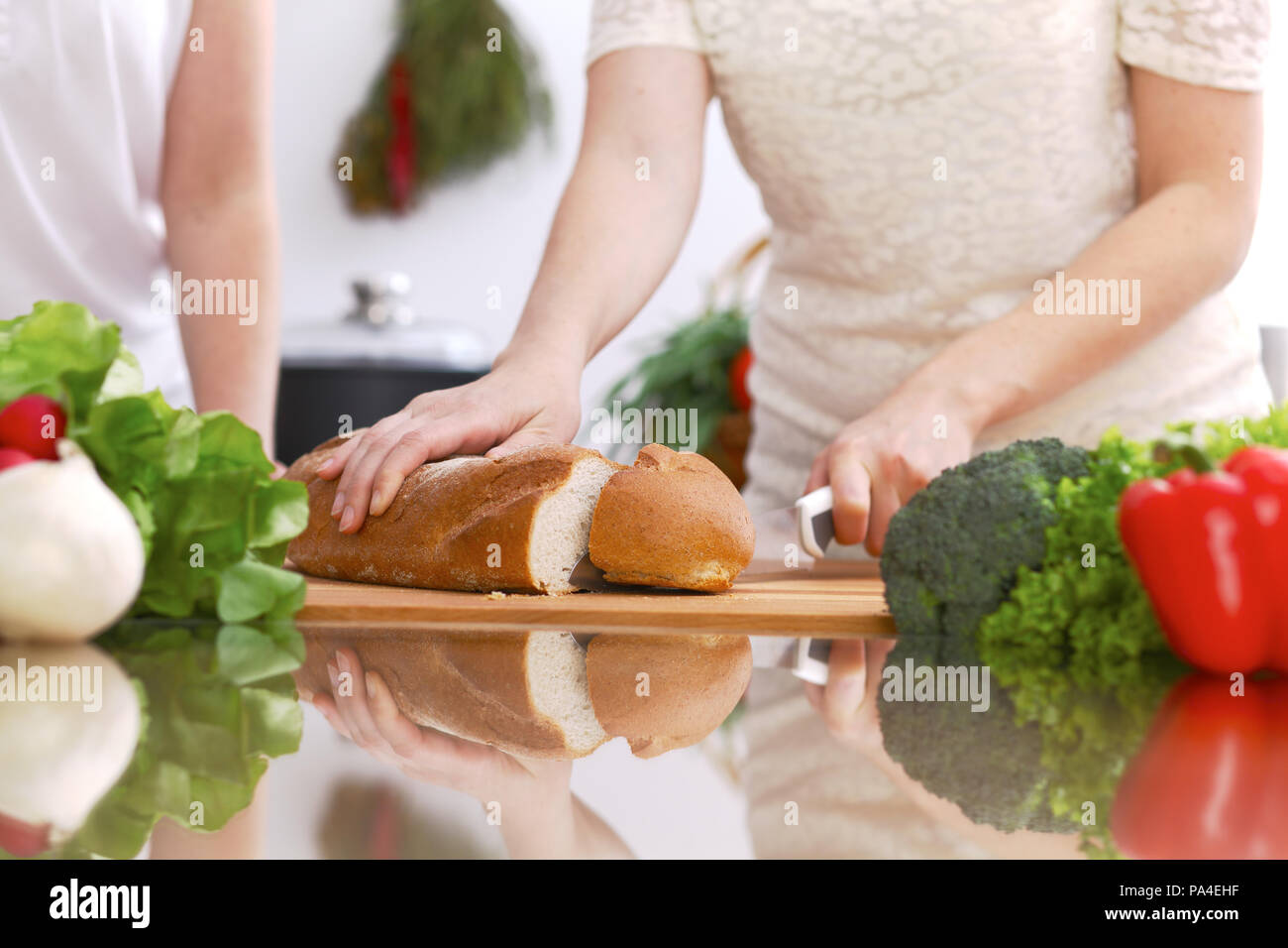 Closeup of human hands cooking in kitchen. Mother and daughter or two ...