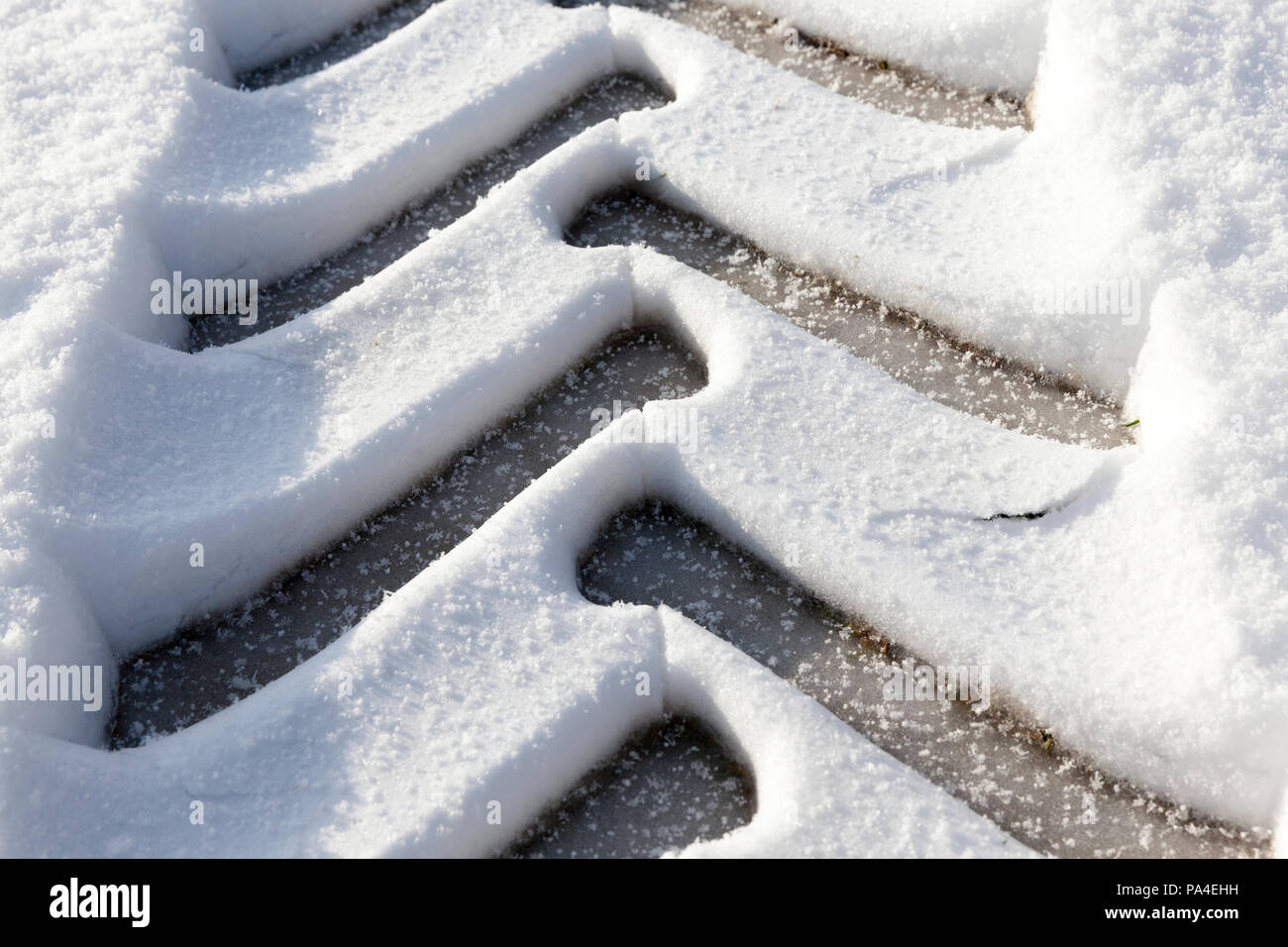 traces of the tractor tread on the snow close-up, the direction of ...
