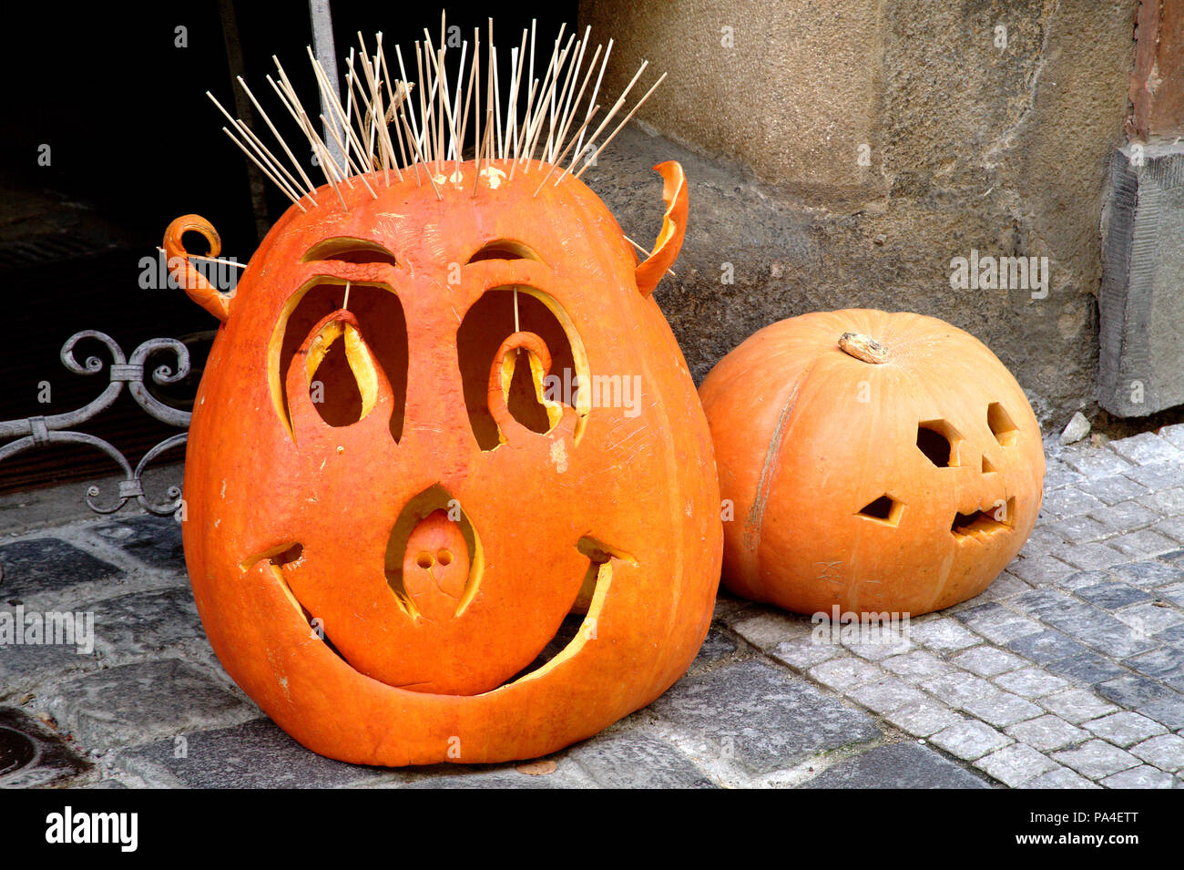 Curved pumpkin faces on the coblestone sidewalk Stock Photo - Alamy