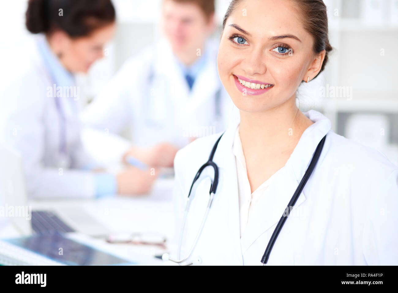 Female doctor working with medical staff at hospital. Teamwork in ...