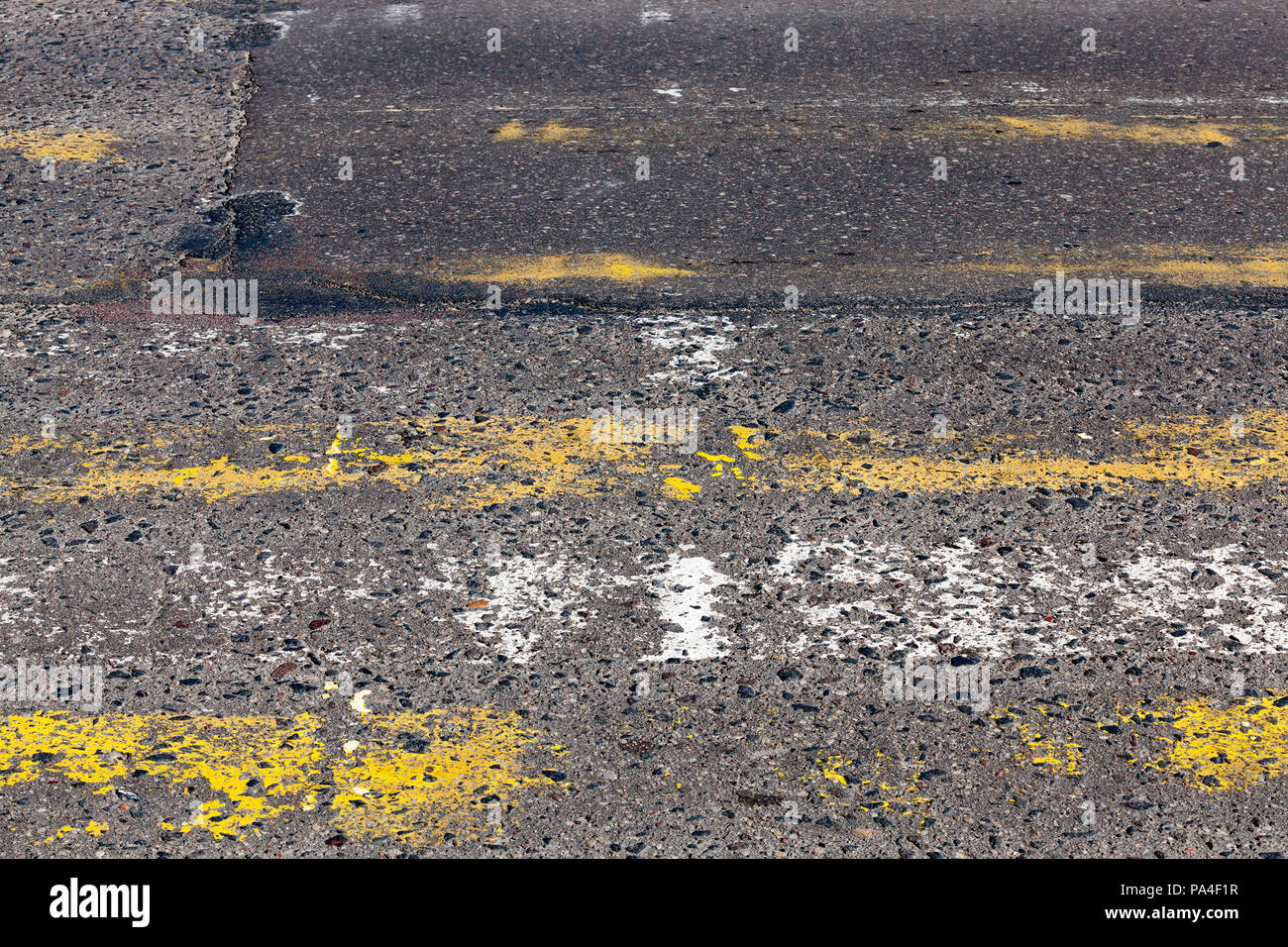 erased and worn road markings on the site of a pedestrian crossing ...