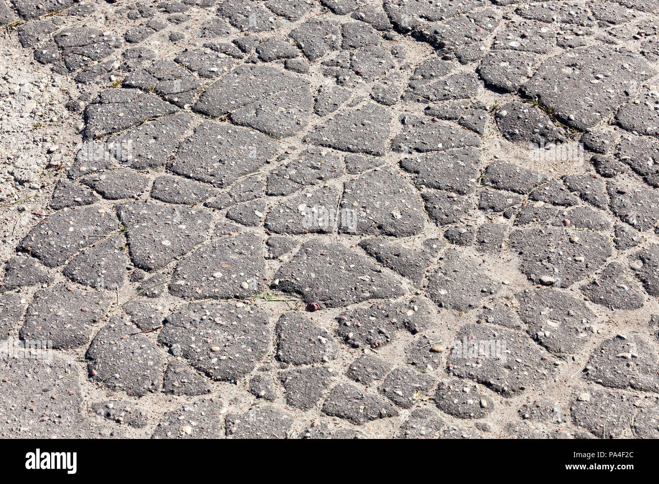 cracked asphalt on part of the road for traffic, closeup and details of ...